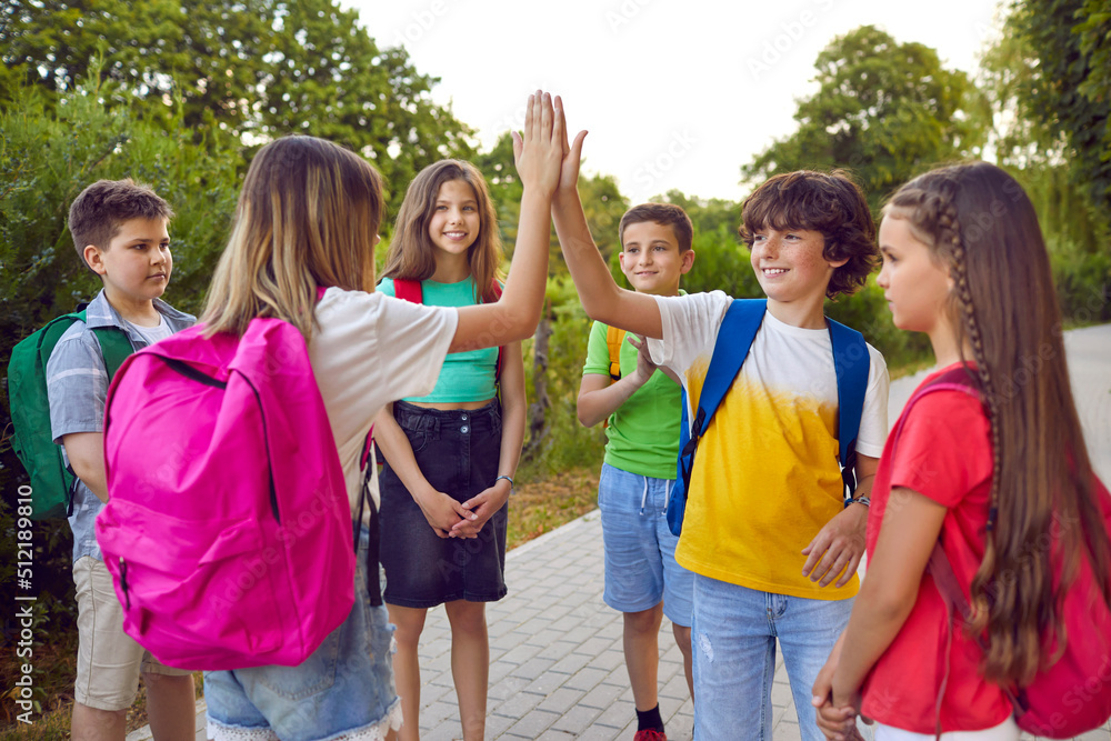Group of school children having fun in the park. Cheerful little ...