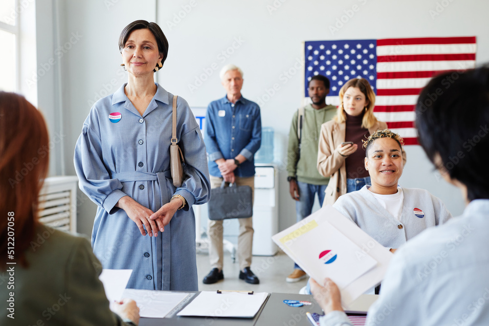Front view portrait of diverse people standing in line on voting day in ...