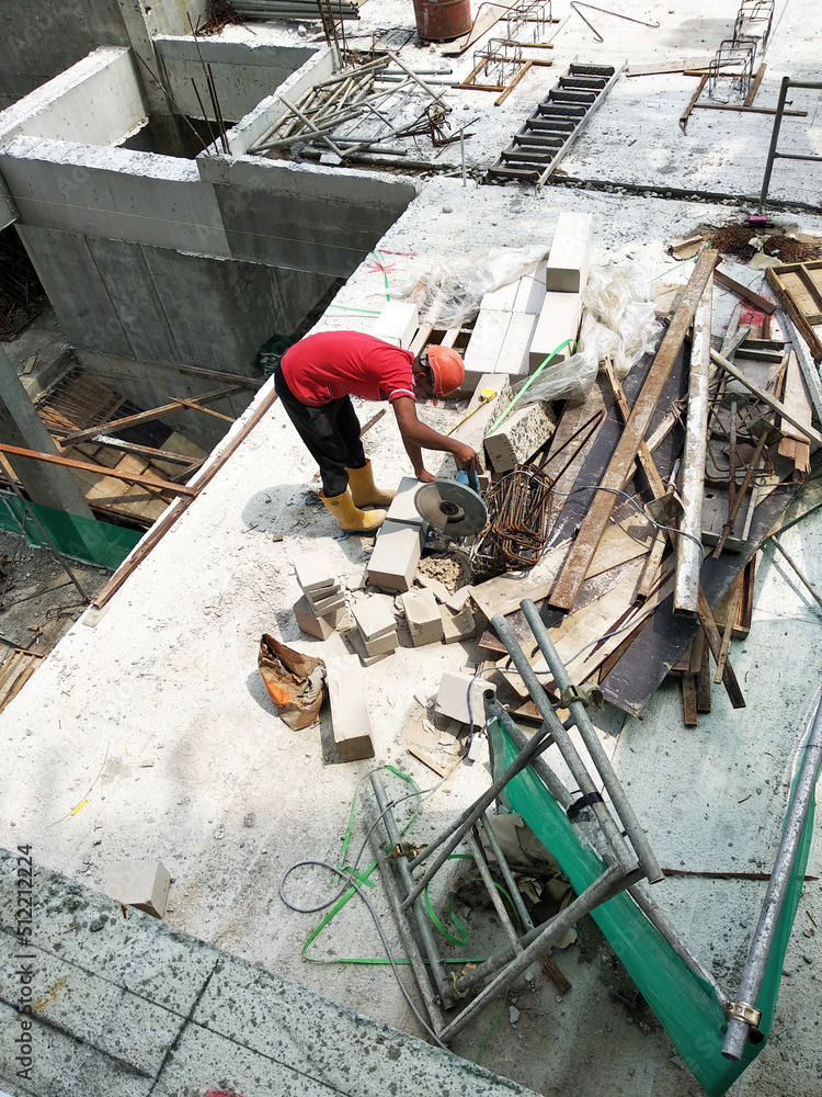 SELANGOR, MALAYSIA -JULY 6, 2021: Construction workers are carrying out ...