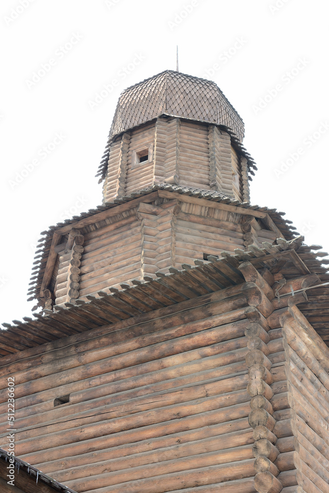 A look from below at a high wooden tower built of round logs. Stock ...