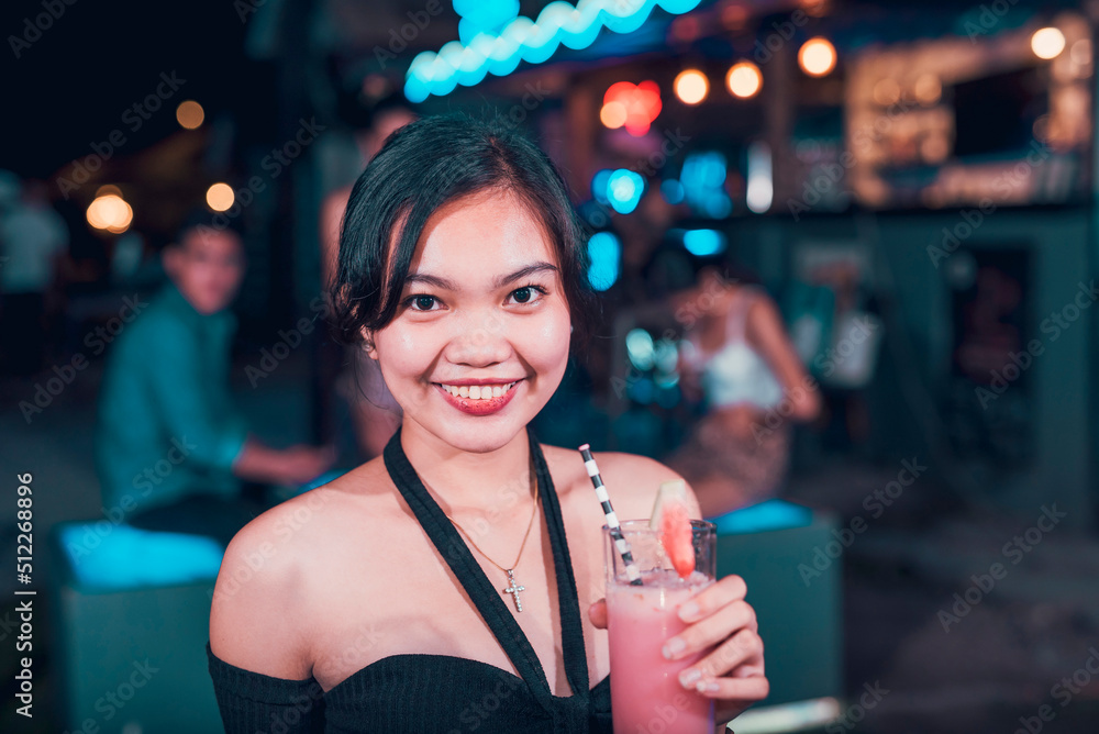 A pretty young FIlipino woman enjoying a watermelon shake at an outdoor ...