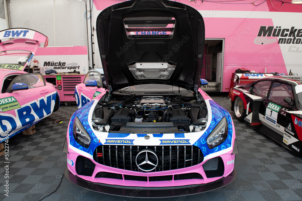 Mercedes AMG GT racing pink super car in box circuit, open hood and ...