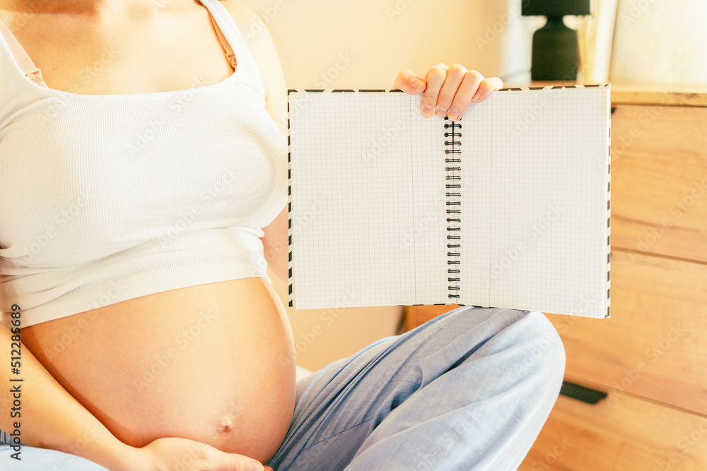 Pregnancy list woman writing. Beautiful pregnant woman writing check ...