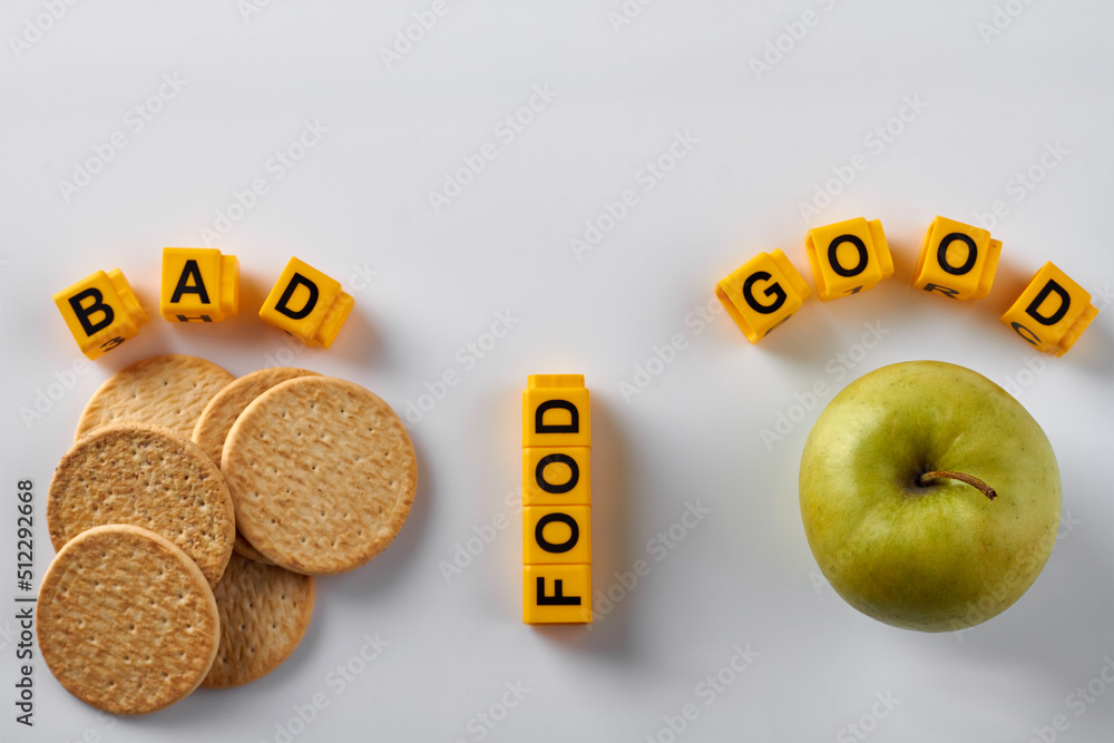 Flat lay concept of good and bad food. Dry cracker cookies and green ...