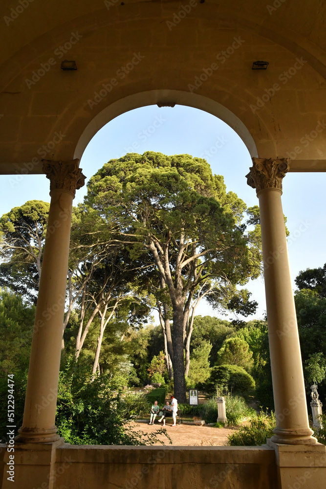 The arch of a small temple in the public park of an Italian village in ...