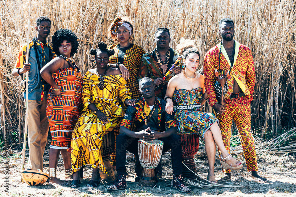 Diverse tribal people in trendy traditional clothes in countryside ...