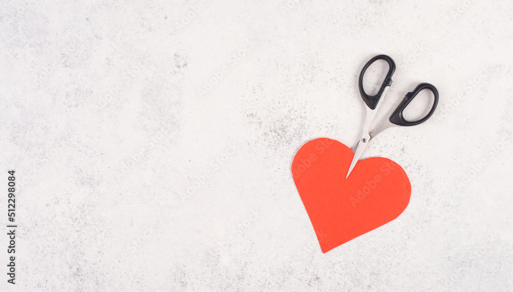 Red heart cut by the scissors, symbol for broken relationship, love and ...