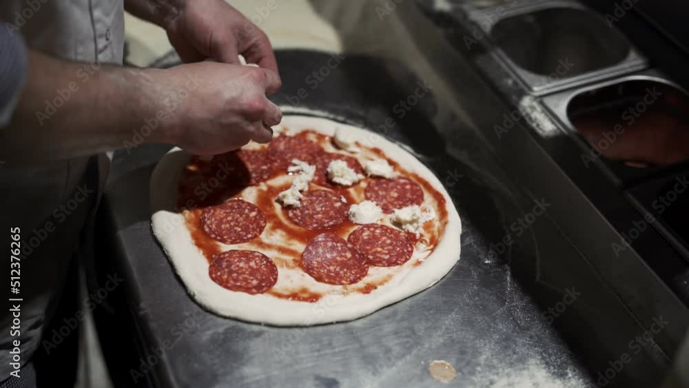 Pizza making process. Male chef hands making authentic pizza in the ...