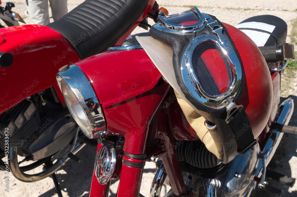 Vintage crash helmet is hanging on the handlebar of a classic oldtimer ...