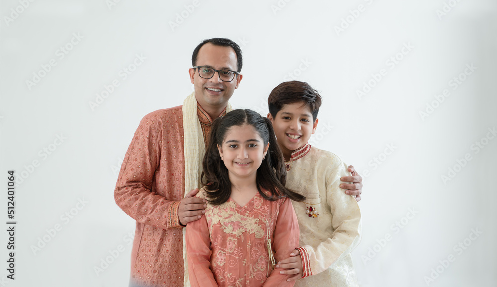 Portrait of happy Indian family standing over white background. Smart young father with little ...