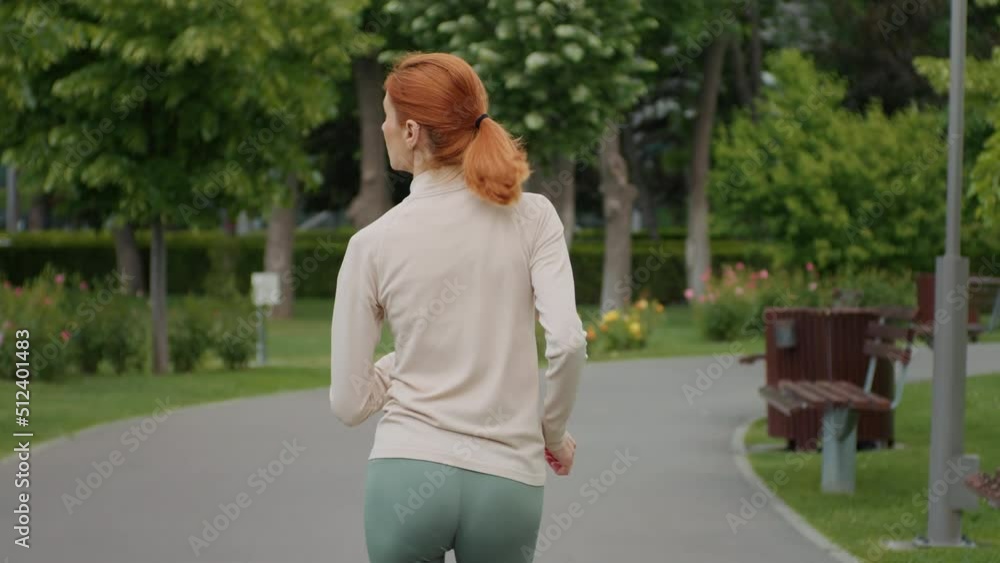 Back view of anorexic woman who started doing jogging in the morning ...