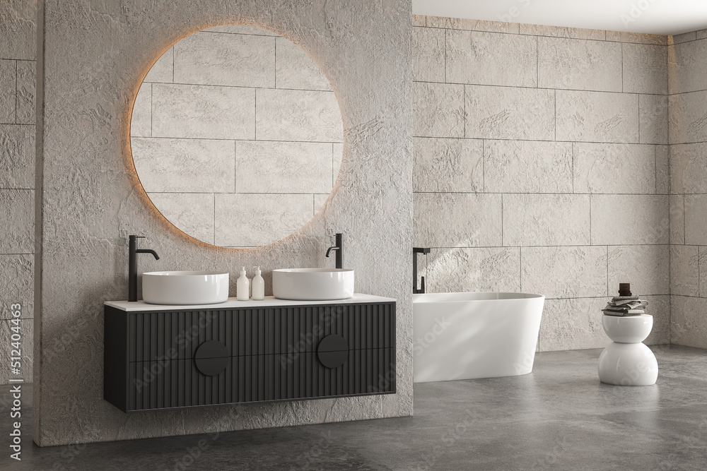 Minimalist bathroom with stone walls, white bathtub and two sinks with ...