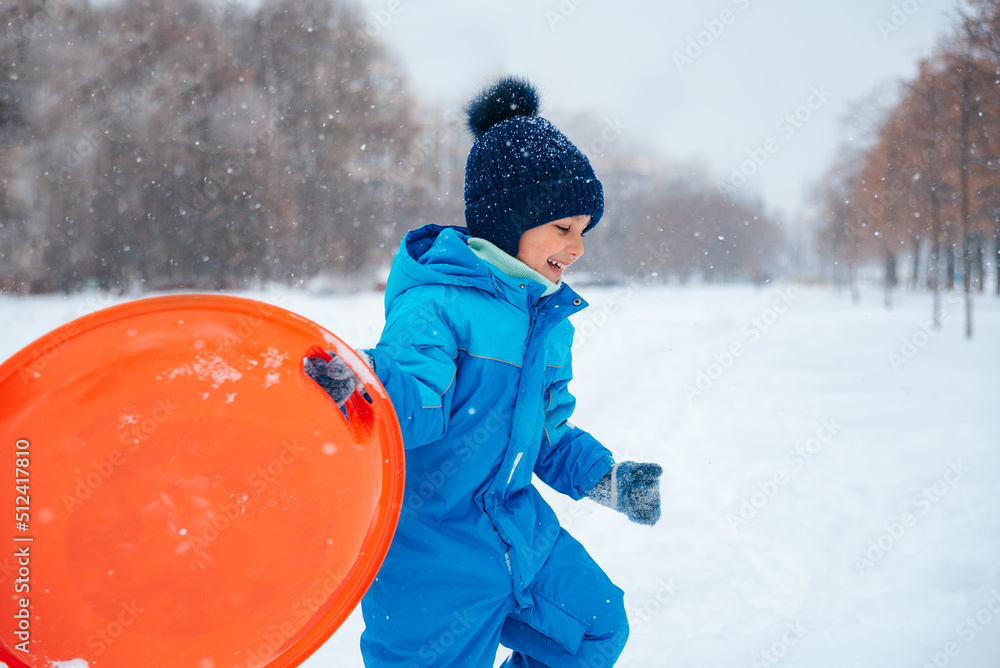 funny little boy playing with snow. child with shovel on a walk in the ...