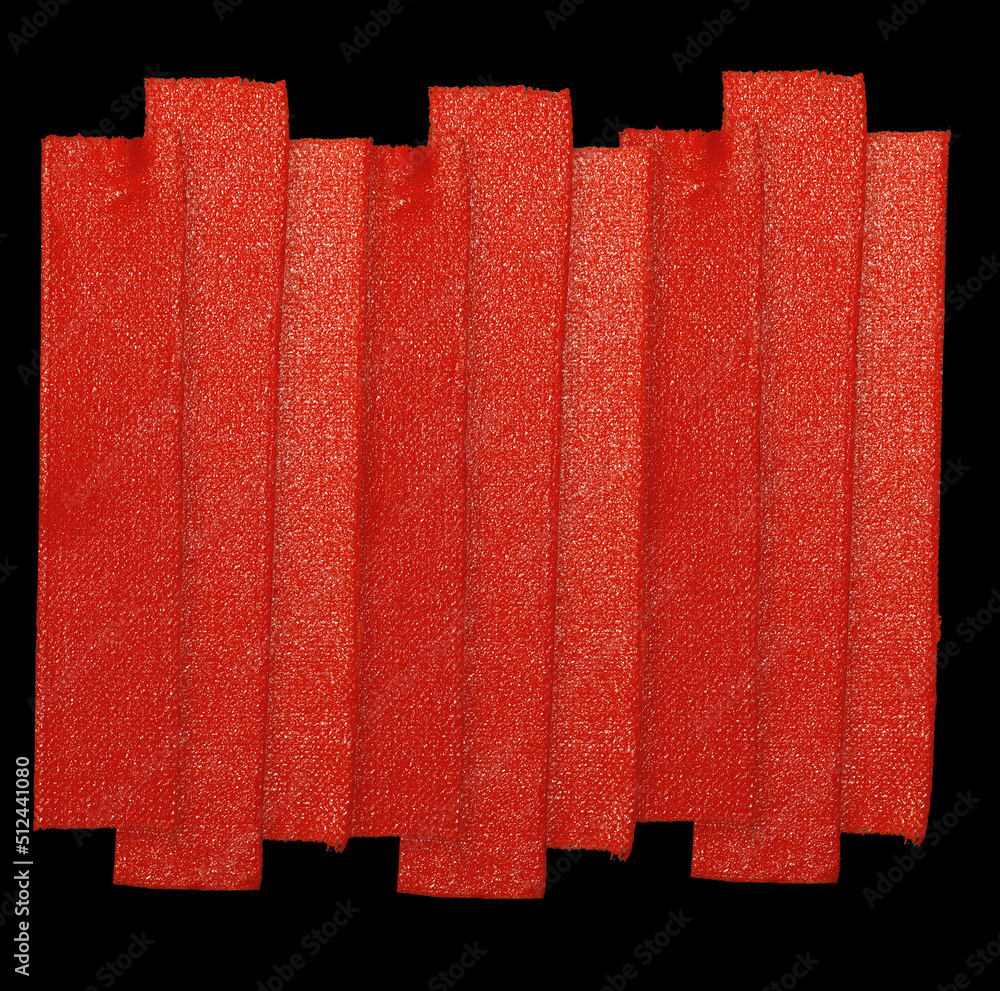 set of red fabric tape stripes overlapping each other on black ...
