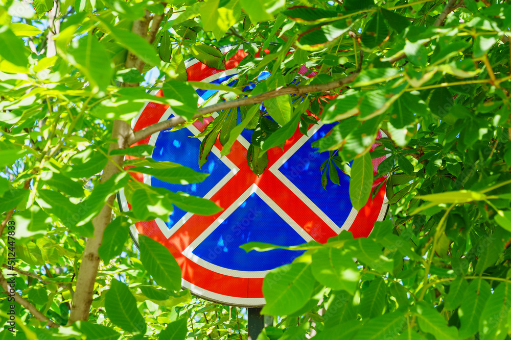 Road sign Stop Prohibited Closed Foliage. Poor visibility of ...