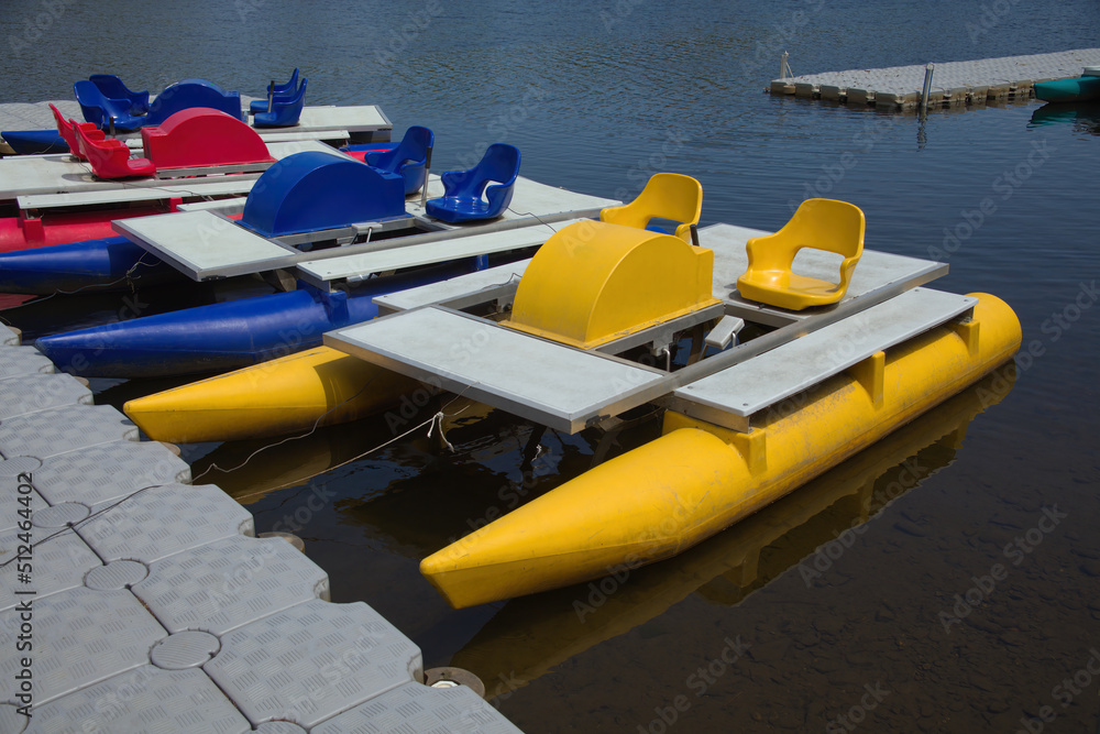 pedalo boats accosted on quay in water summer sport recreation Stock ...