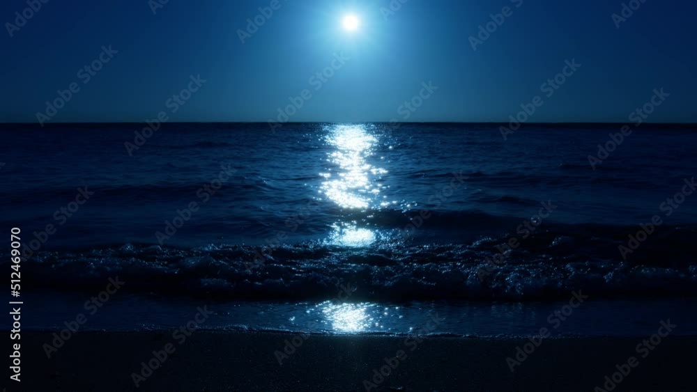 Moonlight over ocean waves washing beach sand. Full moon glowing with ...