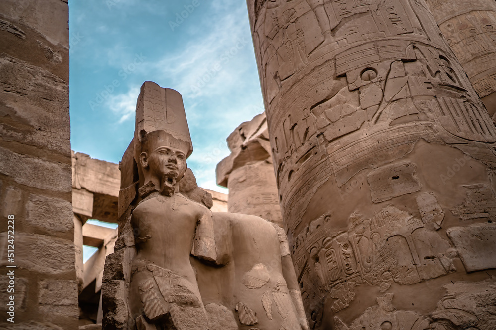 The sculptures of pharaohs and ancient Egyptian drawings on the columns ...