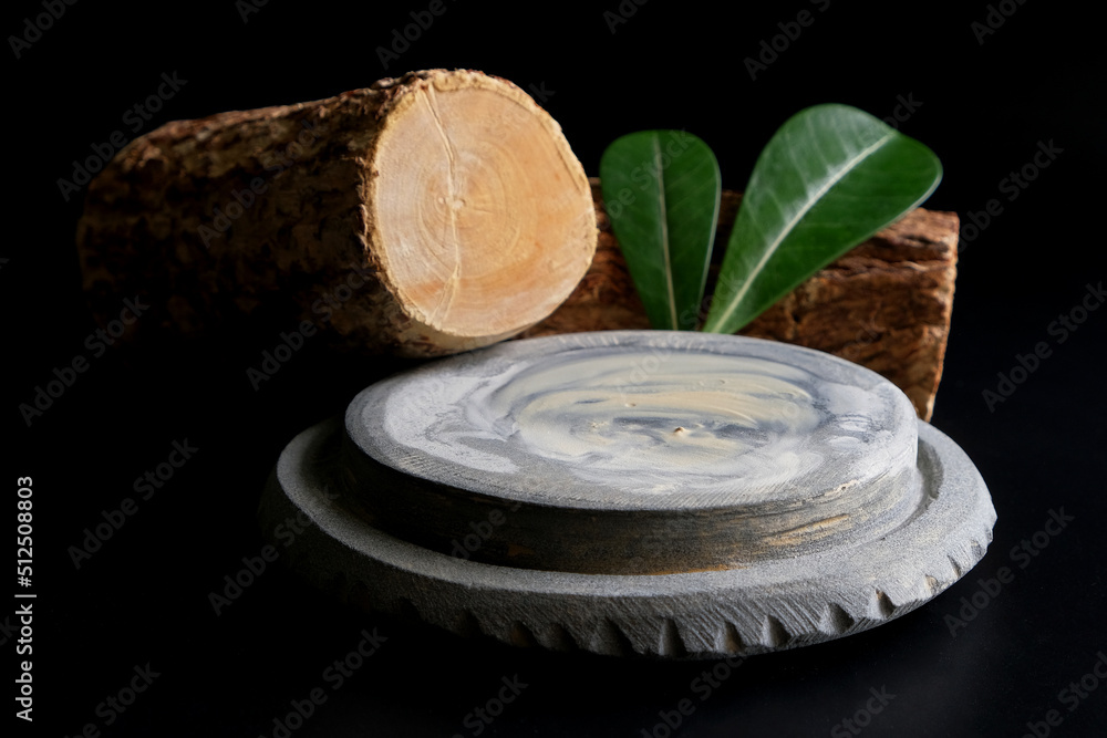 Thanaka wood and stone slabs on a black background. Tanaka is makeup ...
