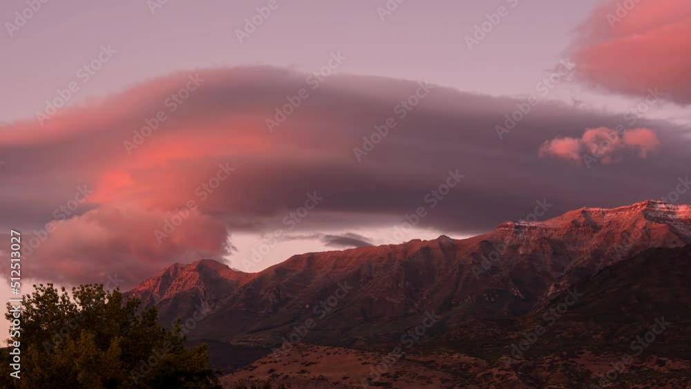 Lenticular clouds during colorful sunset over Timpanogos Mountain in ...