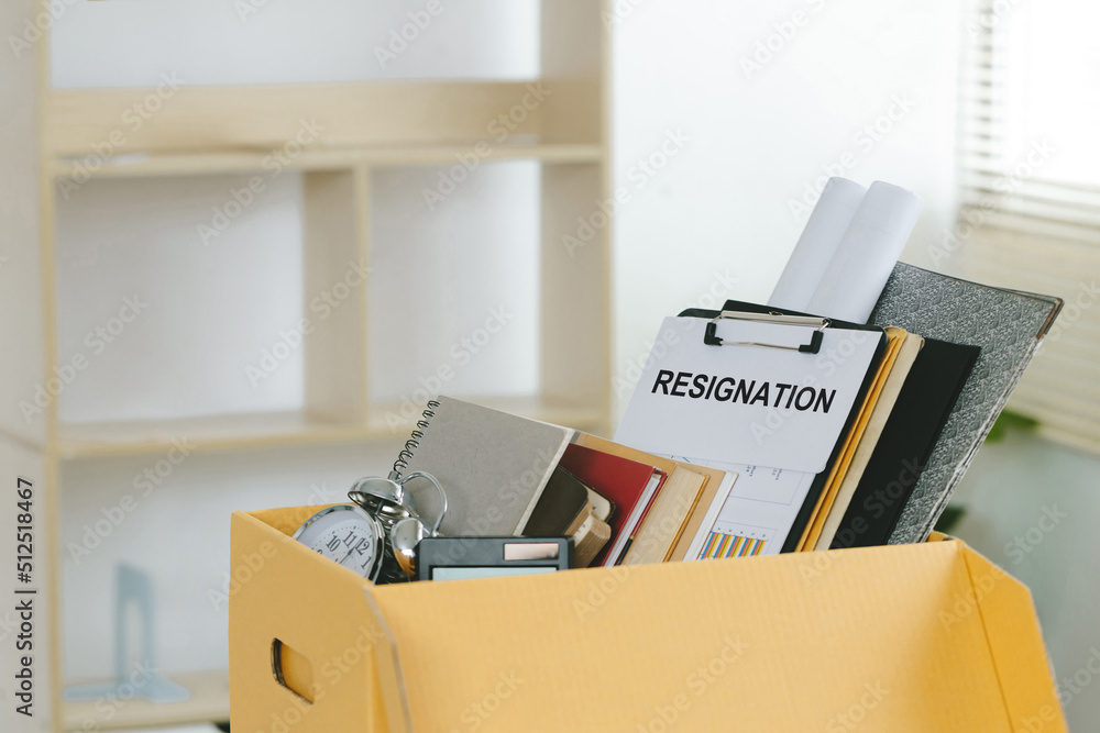 Resignation.Letter of resignation and cardboard box on the desk ...