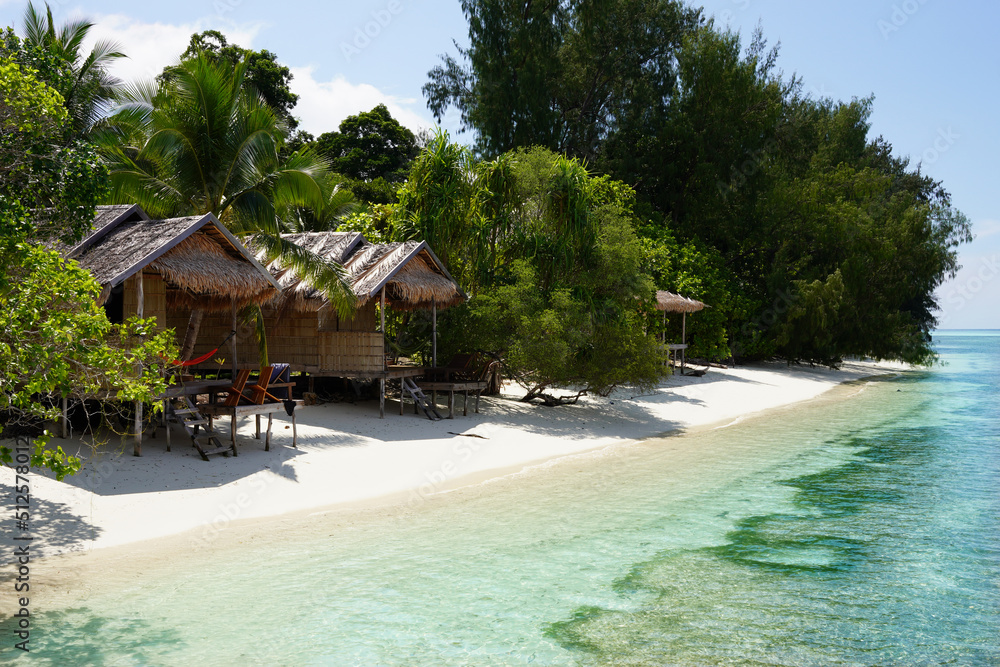 Huts on remote Island in a lagoon Stock Photo | Adobe Stock