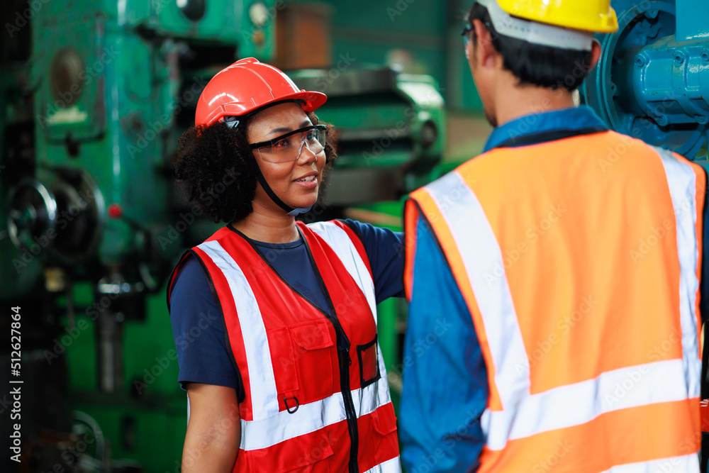 Black Woman worker wearing safety goggles control lathe machine to ...