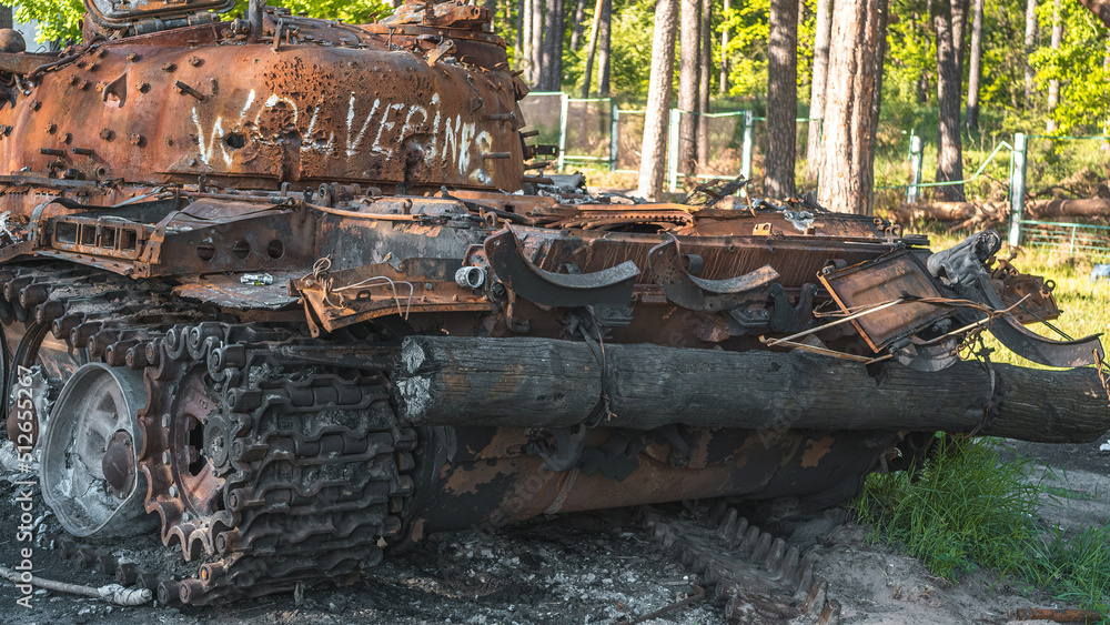 War in Ukraine, a destroyed Russian tank with a Ukrainian ensign stands ...