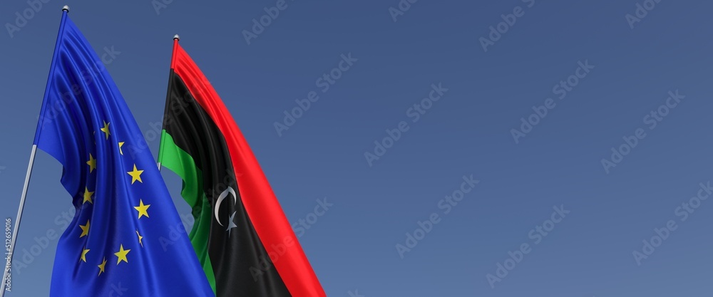 Flags of the European Union and Libya on flagpoles on side. Flags on a ...