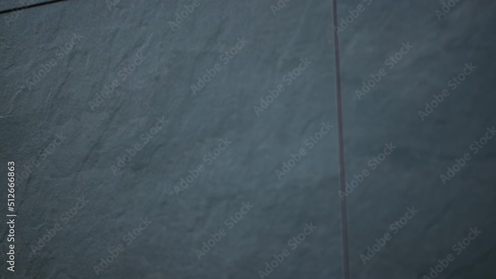 Tracking shot side view of confident young gay man walking down stairs ...