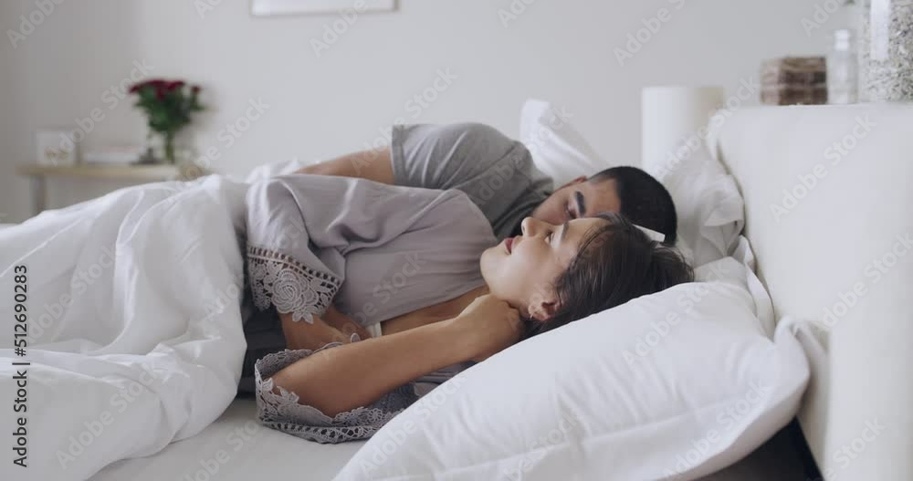 Young content cosy couple taking a nap in a bed at home. boyfriend and ...