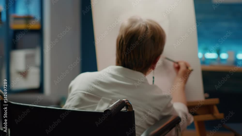Vídeo do Stock: Female wheelchair user with disability drawing vase ...