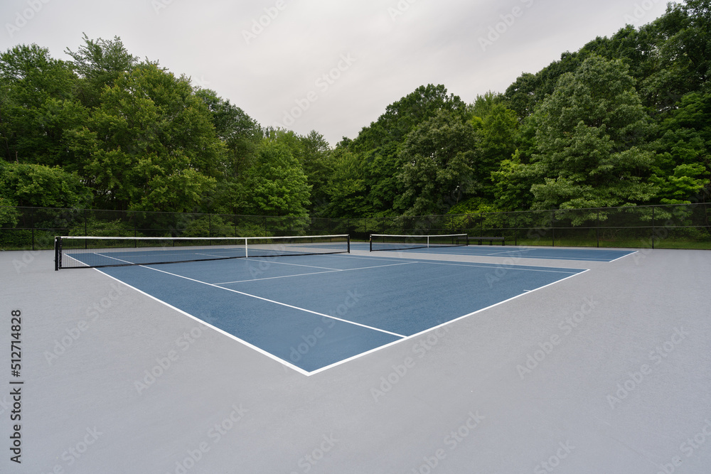 Blue tennis court with white lines and gray out of bounds Stock Photo ...