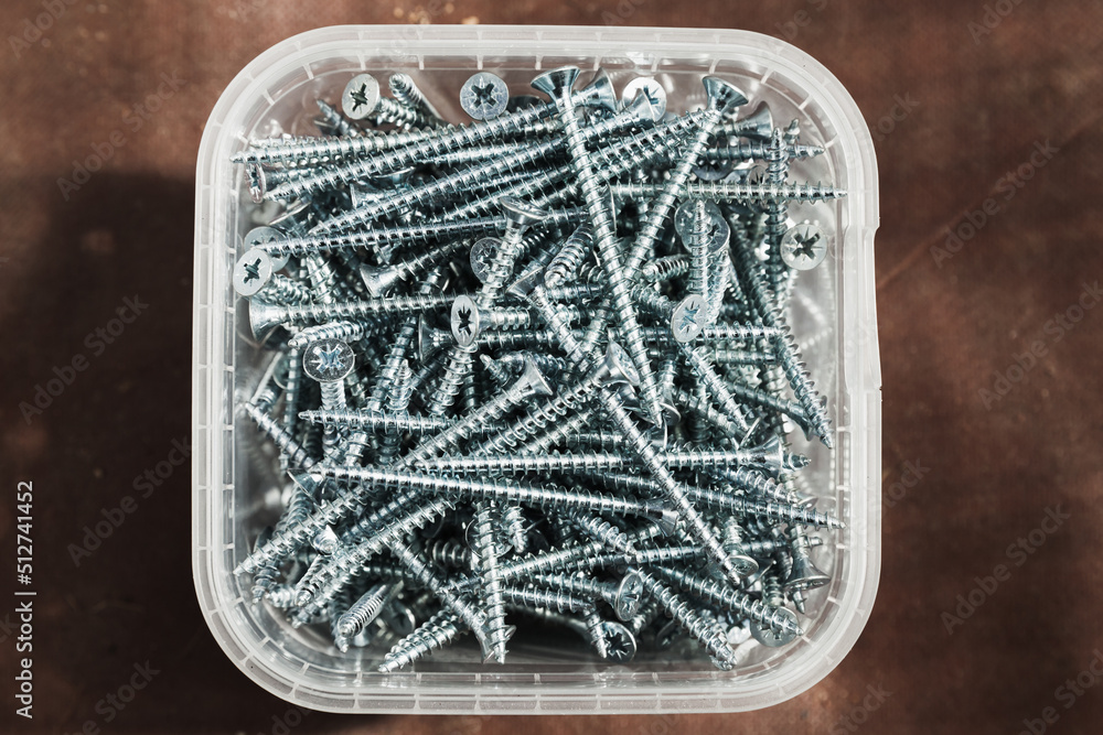 Plastic box of new shiny self-tapping screws Stock Photo | Adobe Stock