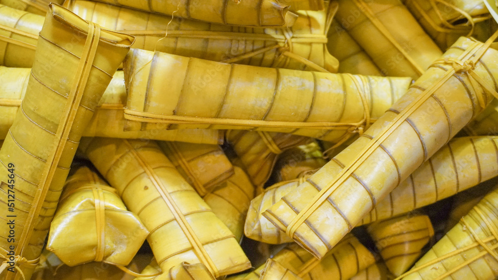 Stack of Suman. Sticky rice cake wrapped in palm leaves. Traditional ...