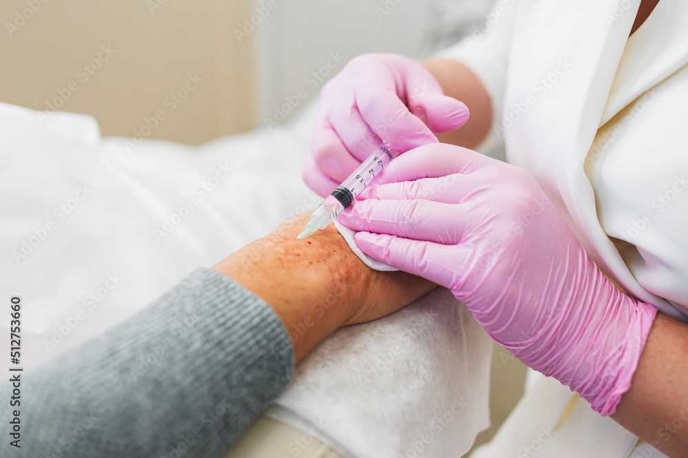 Close-up of a female doctor hand during a subcutaneous injection ...