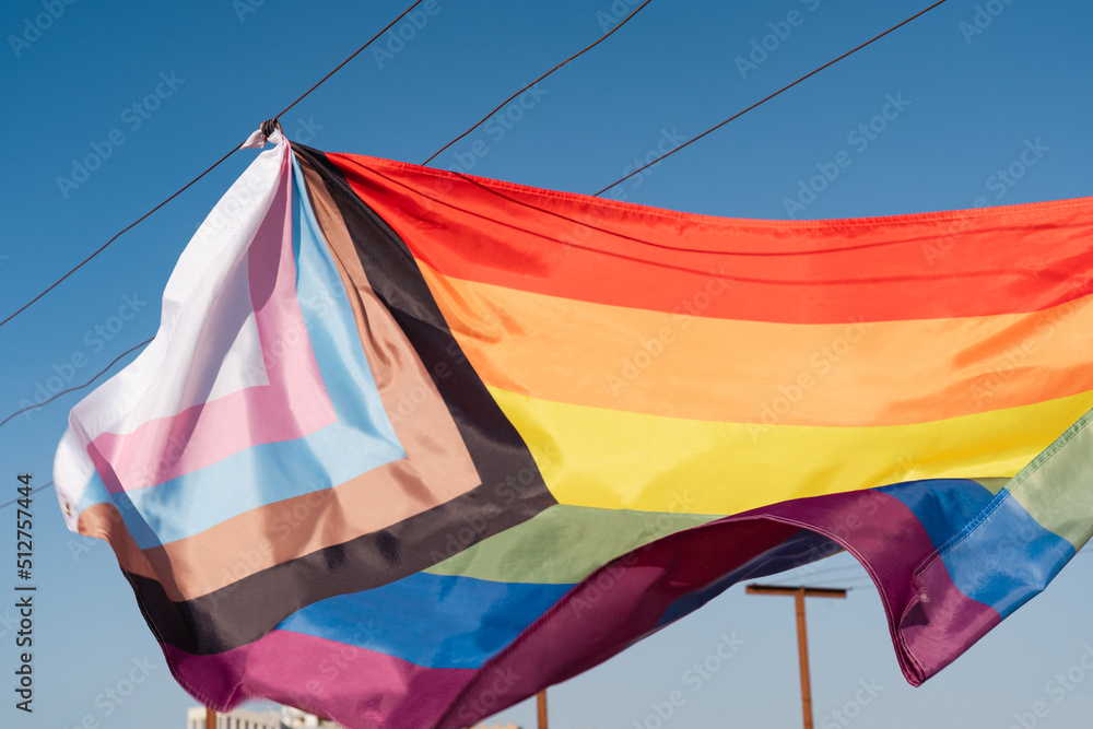 A lgbt flag hanging in the wind on a rooftop, freshly washed ready for ...