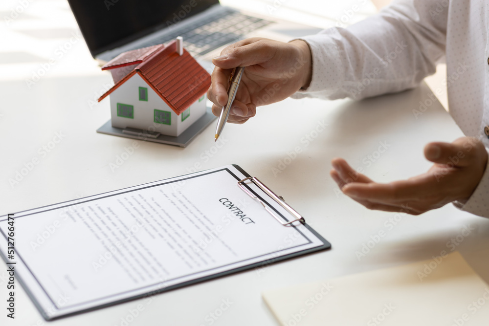 The real estate agent presents the contract documents and explains the ...