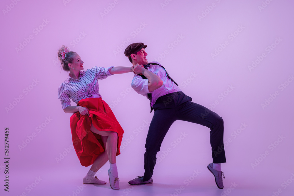 Stylish young man and pretty woman in vintage style outfits dancing ...