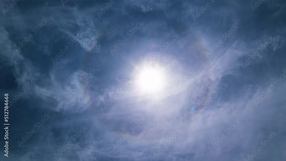 sun halo, Time lapse clouds moving on blue sky with rainbow ring around ...
