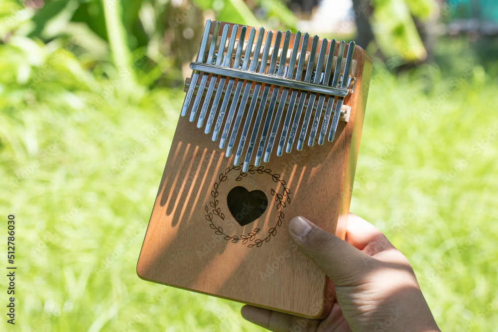 Hand playing kalimba or mbira is an African musical instrument.made ...