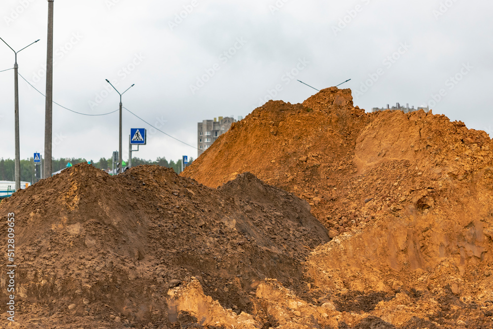 Soil excavation at the construction site. A pile of sand and earth ...