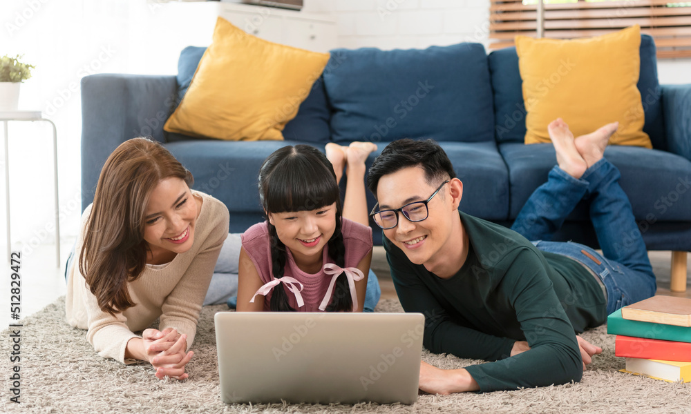 Happy Asian family using computer laptop together at home in living ...