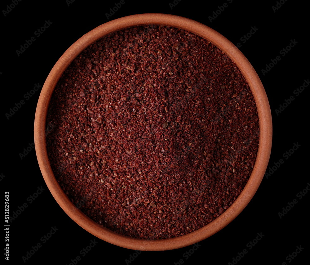 Ground sumac spice, pile in clay pot isolated on black, top view Stock ...