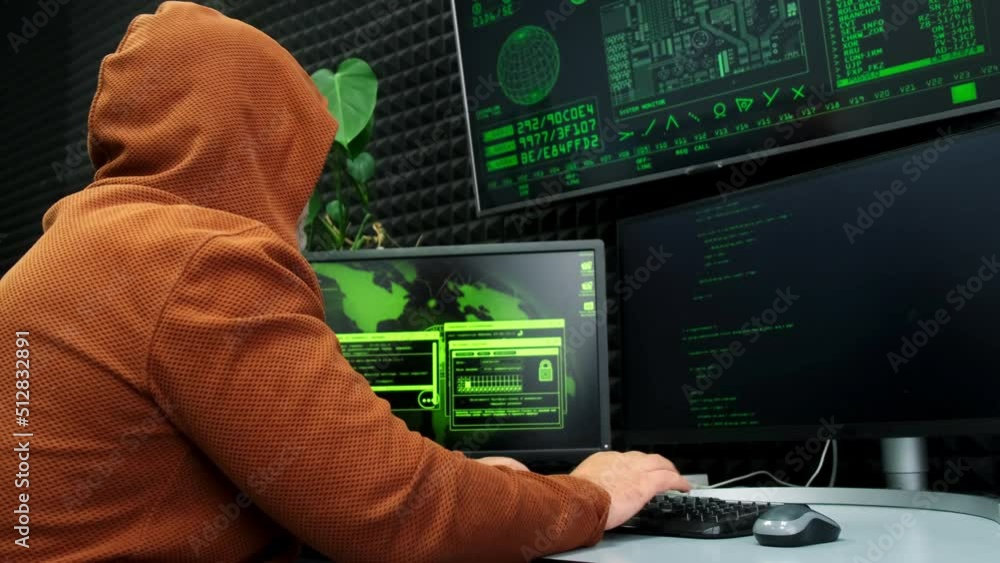 Unrecognizable Male Hacker In A Hoodie Is Typing On A Computer Keyboard