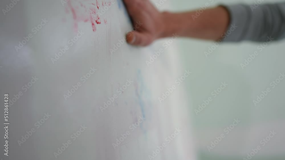 Close-up male hand touching wall leaving colored prints of palm ...