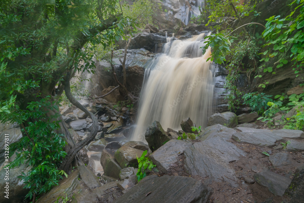 Beautiful Bamni waterfall having full streams of water flowing downhill ...