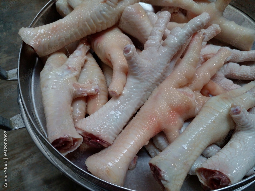 Chicken feet that have been cleaned and washed are placed in an ...