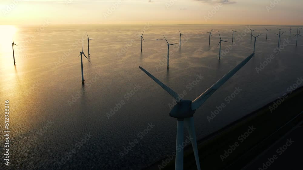Working offshore wind farm, sunset view. Aerial view of wind turbines ...