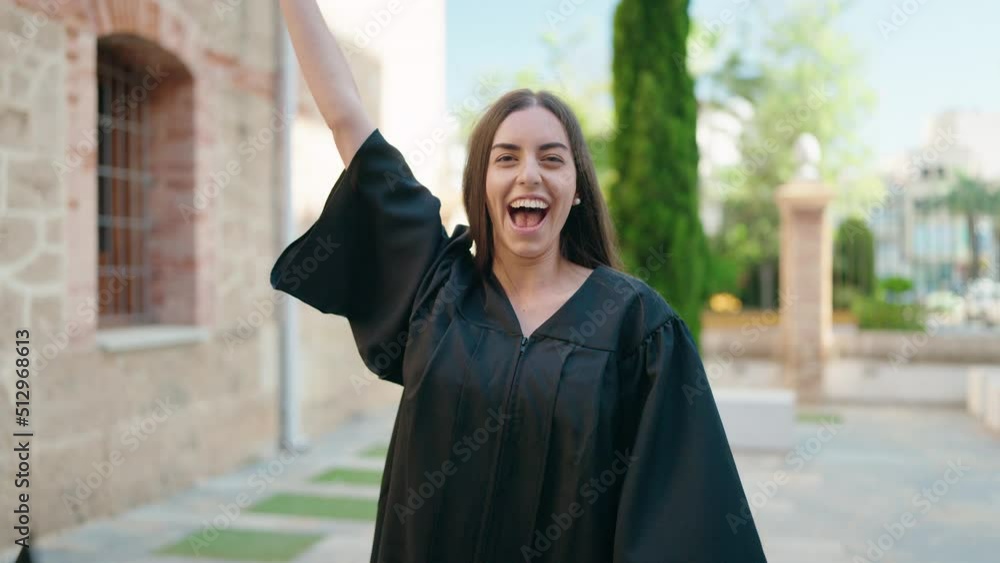 Young hispanic woman smiling confident throwing hat for graduation at ...